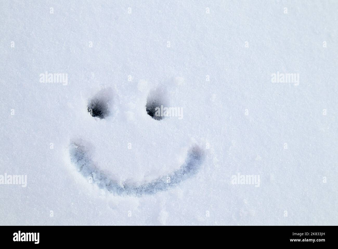 Figure face drawn on the snow, smile and eyes, emotions. Postcard Stock ...