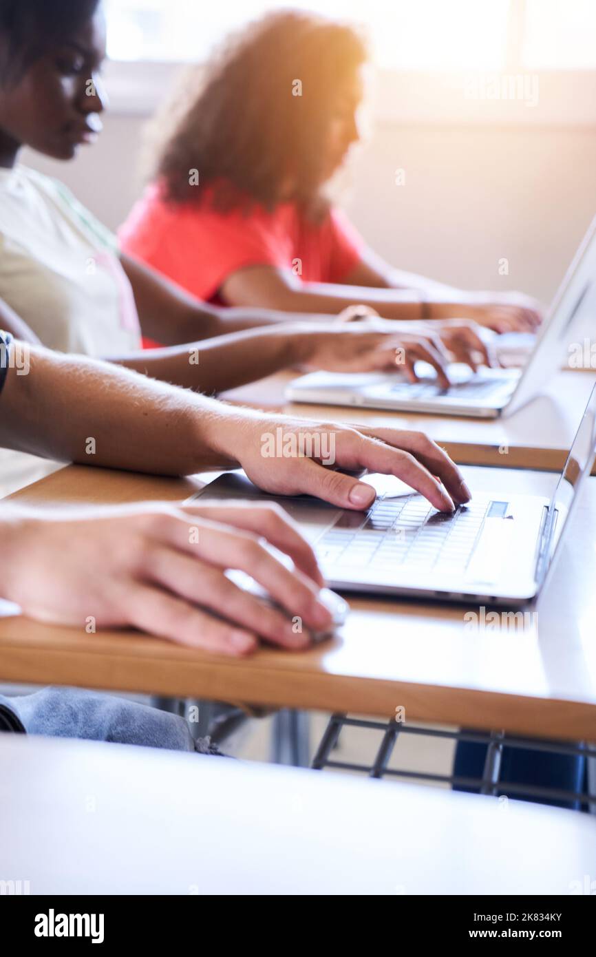 Vertical Close-up of the laptop in the classroom. A multi-ethnic group ...