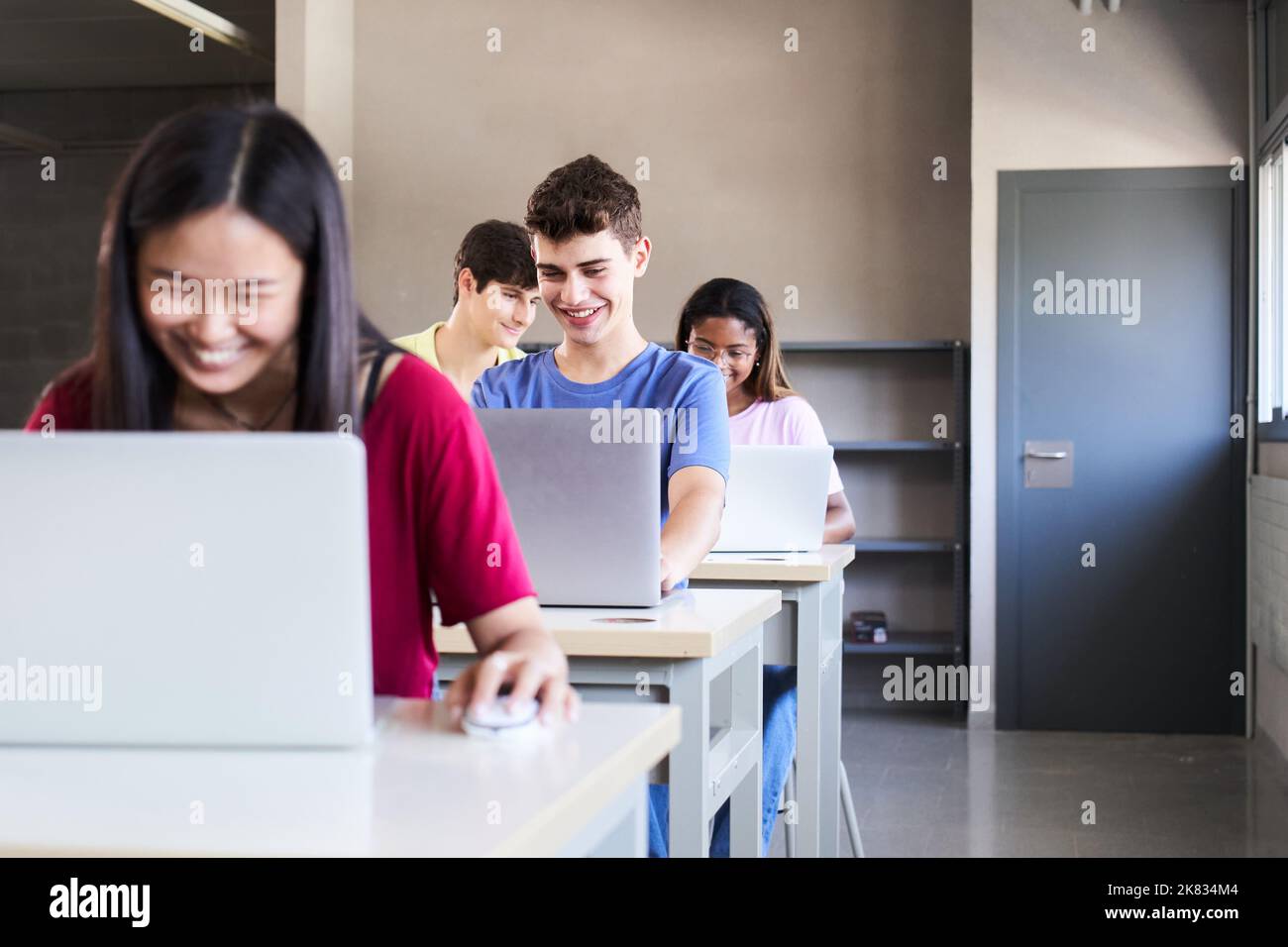 Large Group of Multi Ethnic smiling Students Working on the Laptops ...