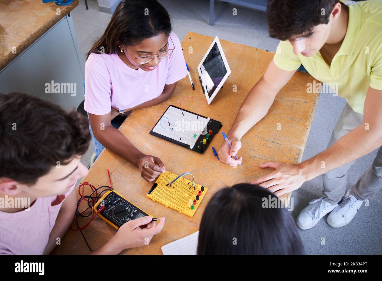 Top view of a group of technical college students doing a team ...