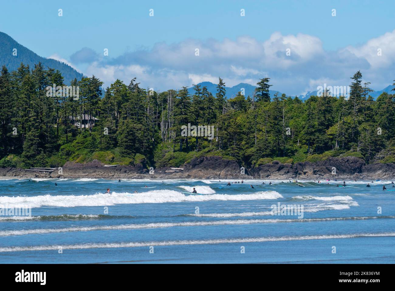People learn to surf at Cox Beach, near Tofino on a beautiful summer ...