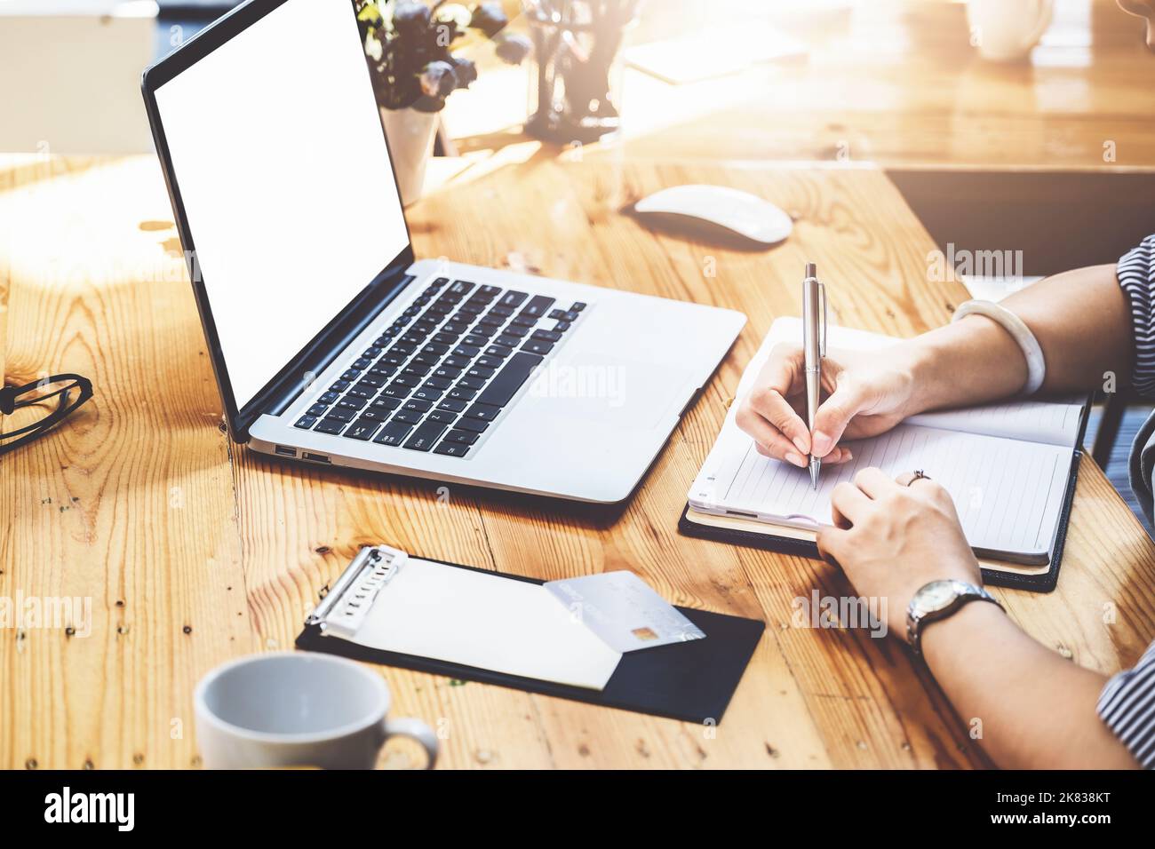 learning, note taking, planning, female employee holding a pen to write ...