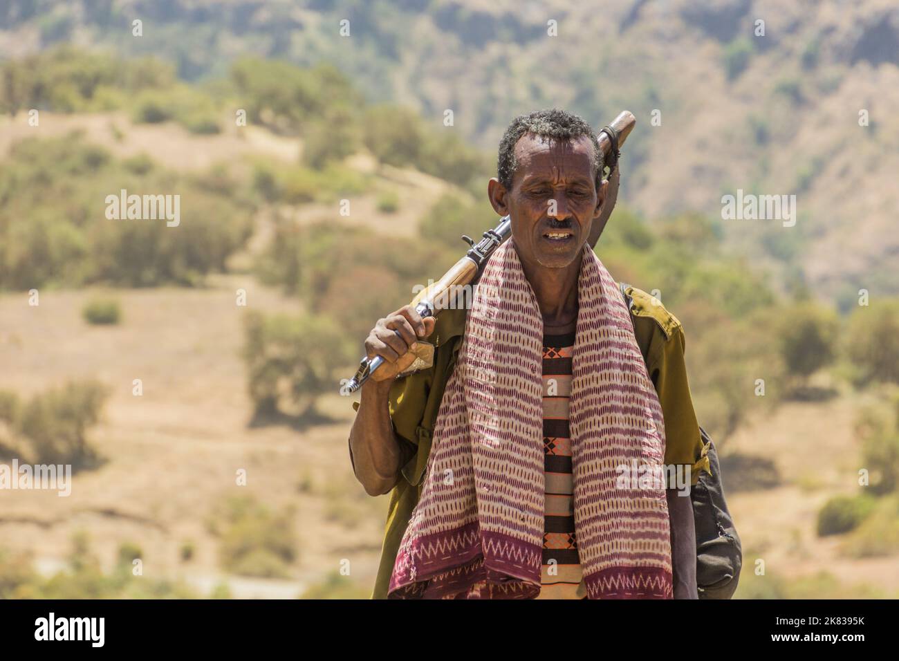 SIMIEN MOUNTAINS, ETHIOPIA - MARCH 15, 2019: Armed scout guarding ...