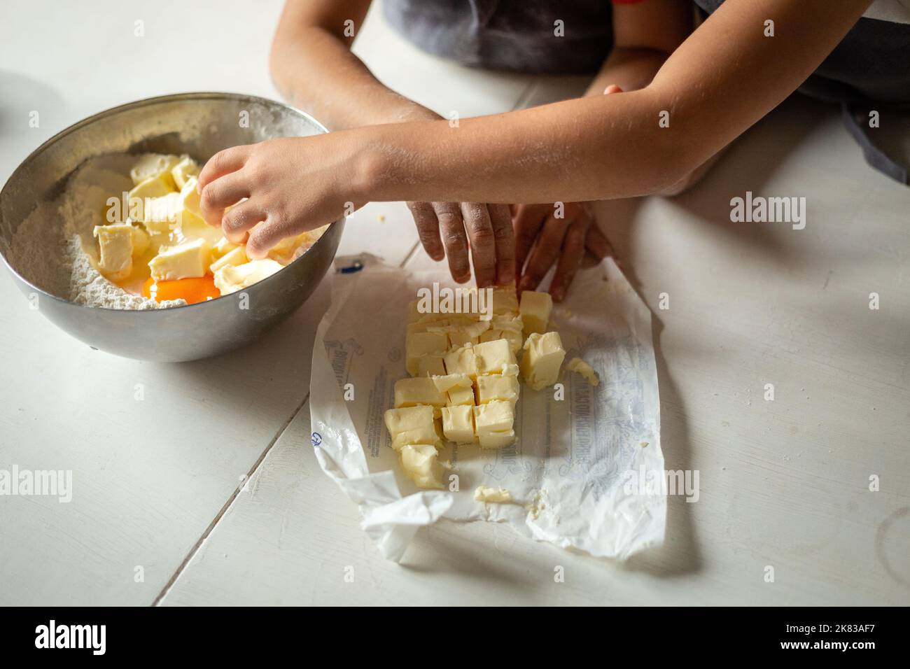 close view of children hands adding butter to flour Stock Photo - Alamy