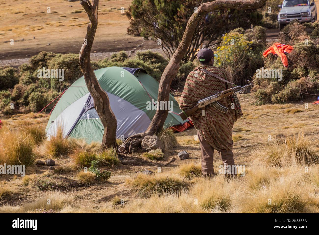 SIMIEN MOUNTAINS, ETHIOPIA - MARCH 16, 2019: Armed scout guarding ...