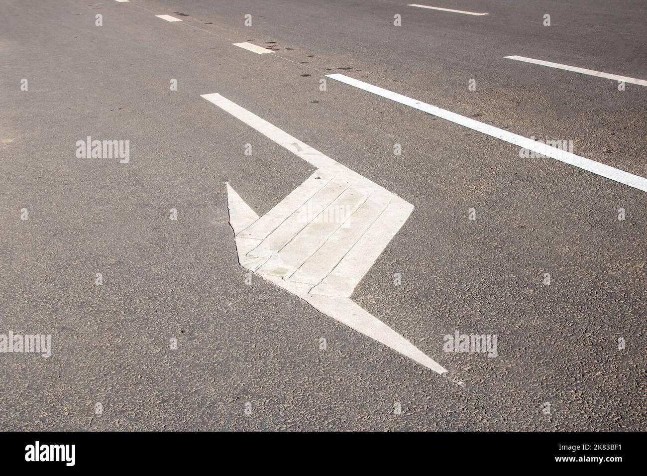 Arrow road markings on the asphalt close up Stock Photo - Alamy