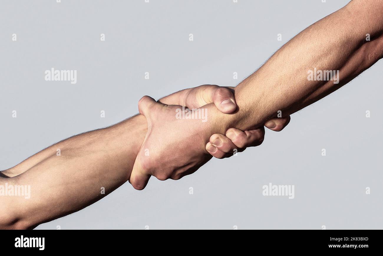 Helping hand concept, support. A friendly handshake. Two hands, shaking ...