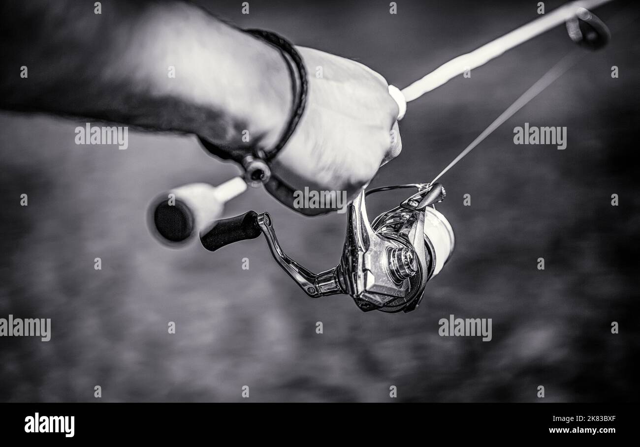 Fisherman hand holding fishing rod with reel. Fishing Reel. Fishing Rod ...
