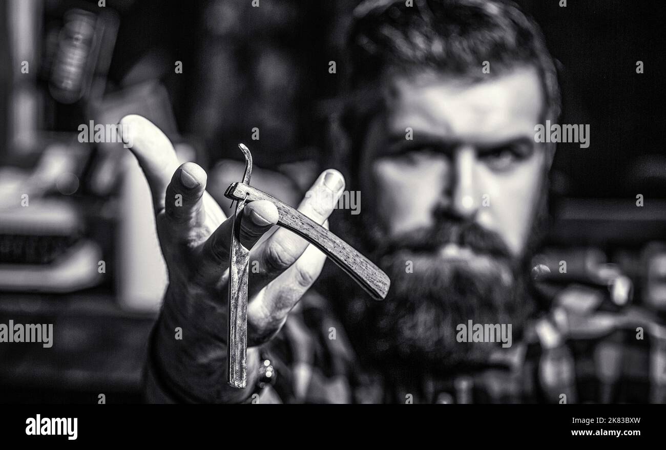 Straight razor, barbershop, beard. Portrait of brutal bearded man ...
