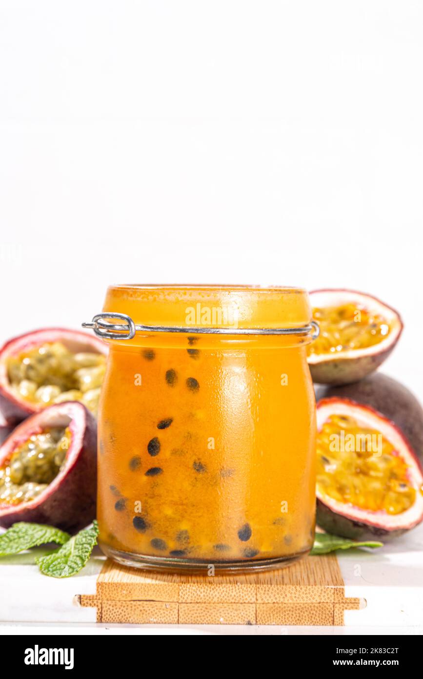 Homemade passion fruit jam in small jar, with fresh passion fruit and ...