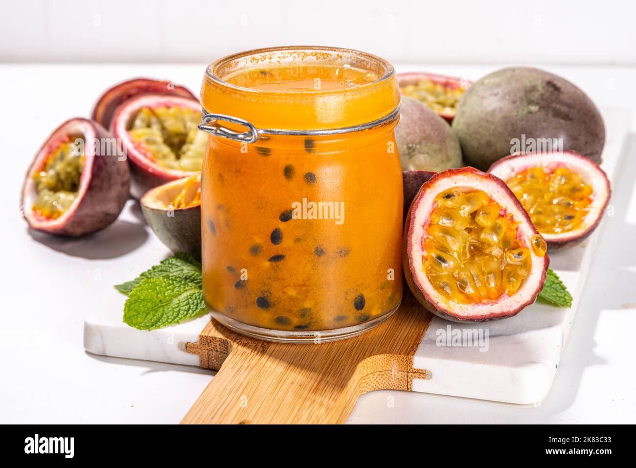 Homemade passion fruit jam in small jar, with fresh passion fruit and ...
