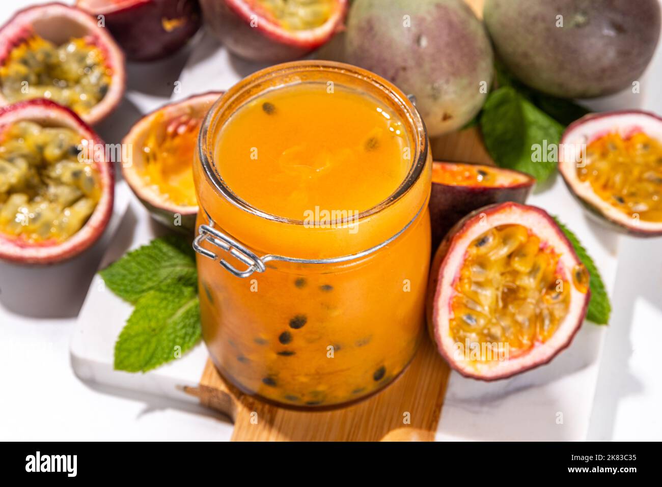 Homemade passion fruit jam in small jar, with fresh passion fruit and ...