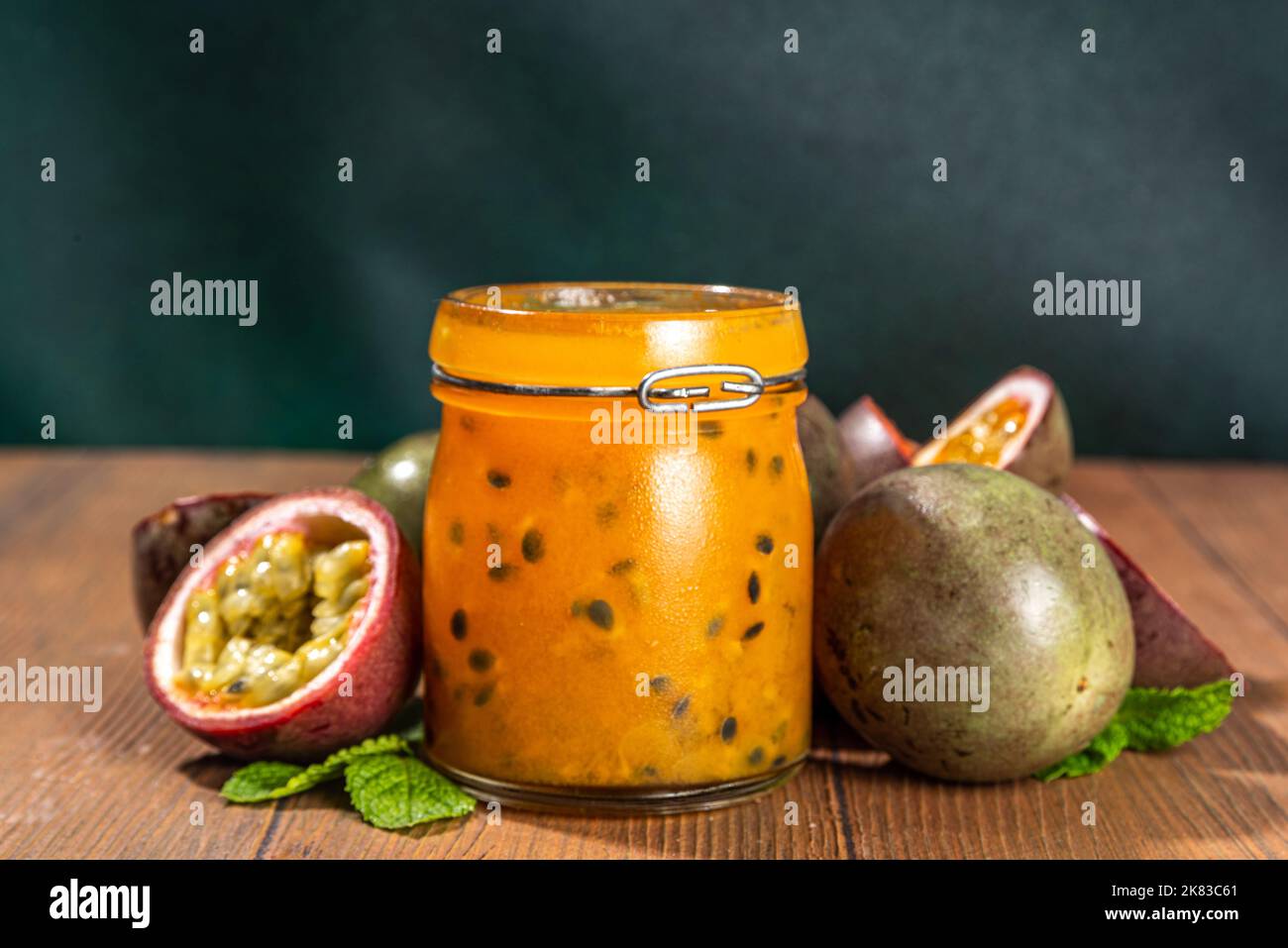 Homemade passion fruit jam in small jar, with fresh passion fruit and ...