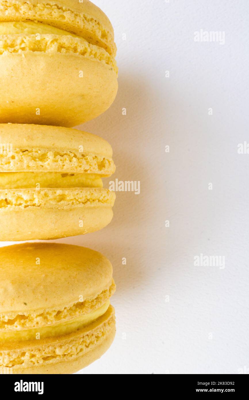 Three yellow lemon flavoured French macarons on white background Stock ...
