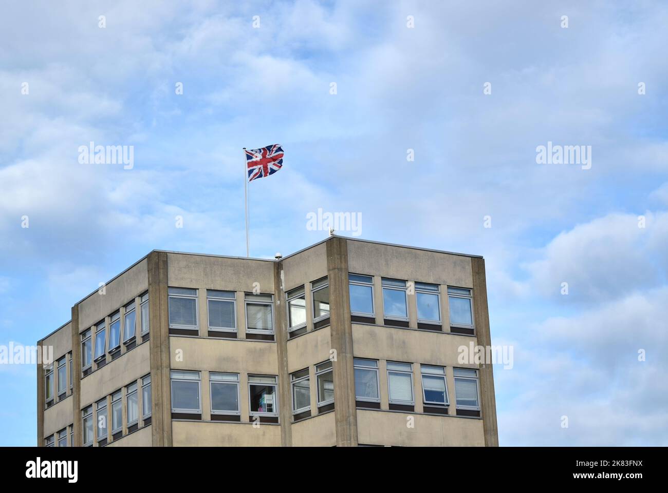 British flag on a building with cloudy background Stock Photo - Alamy