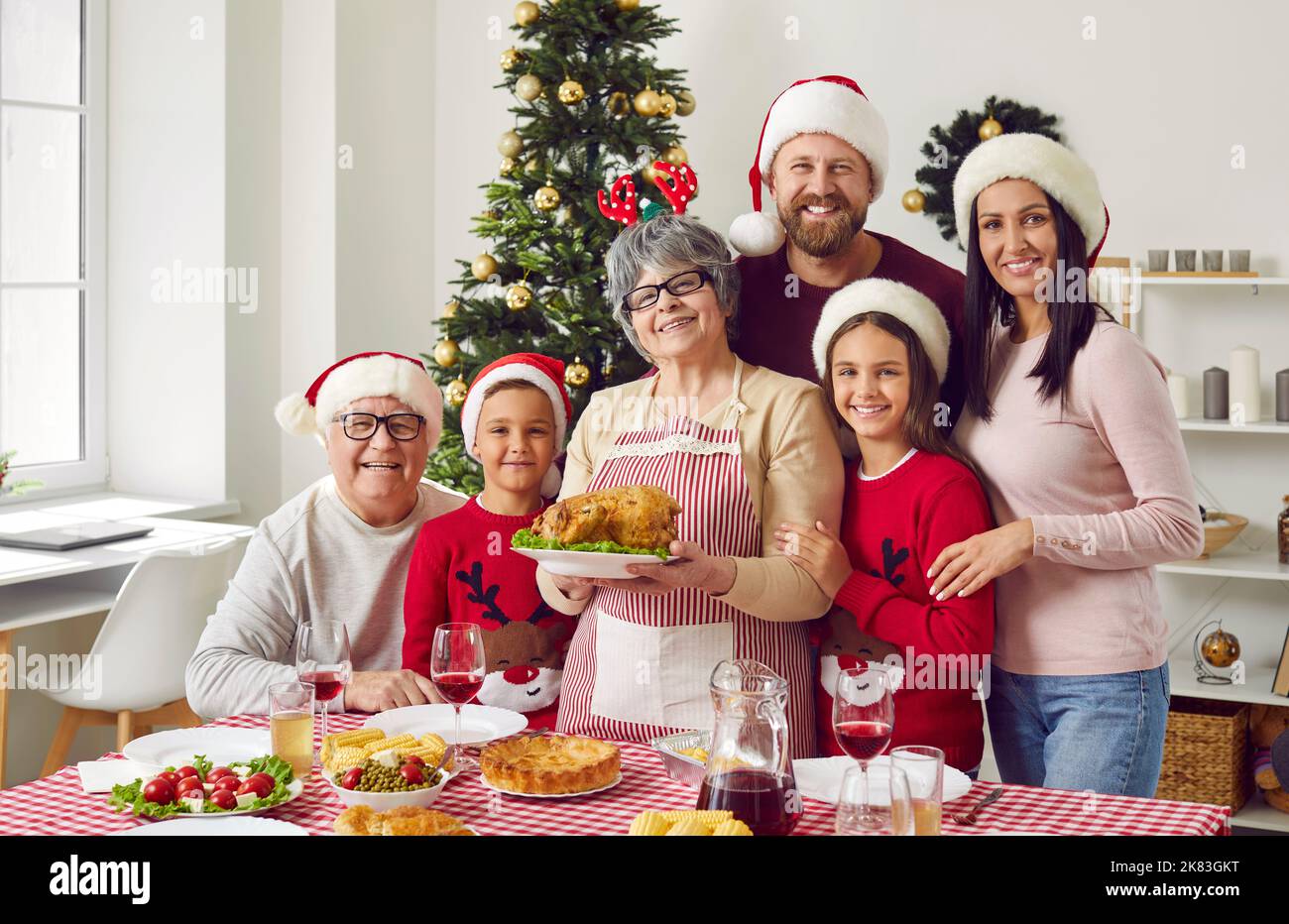 Multi-generational family with elderly woman standing in center with ...