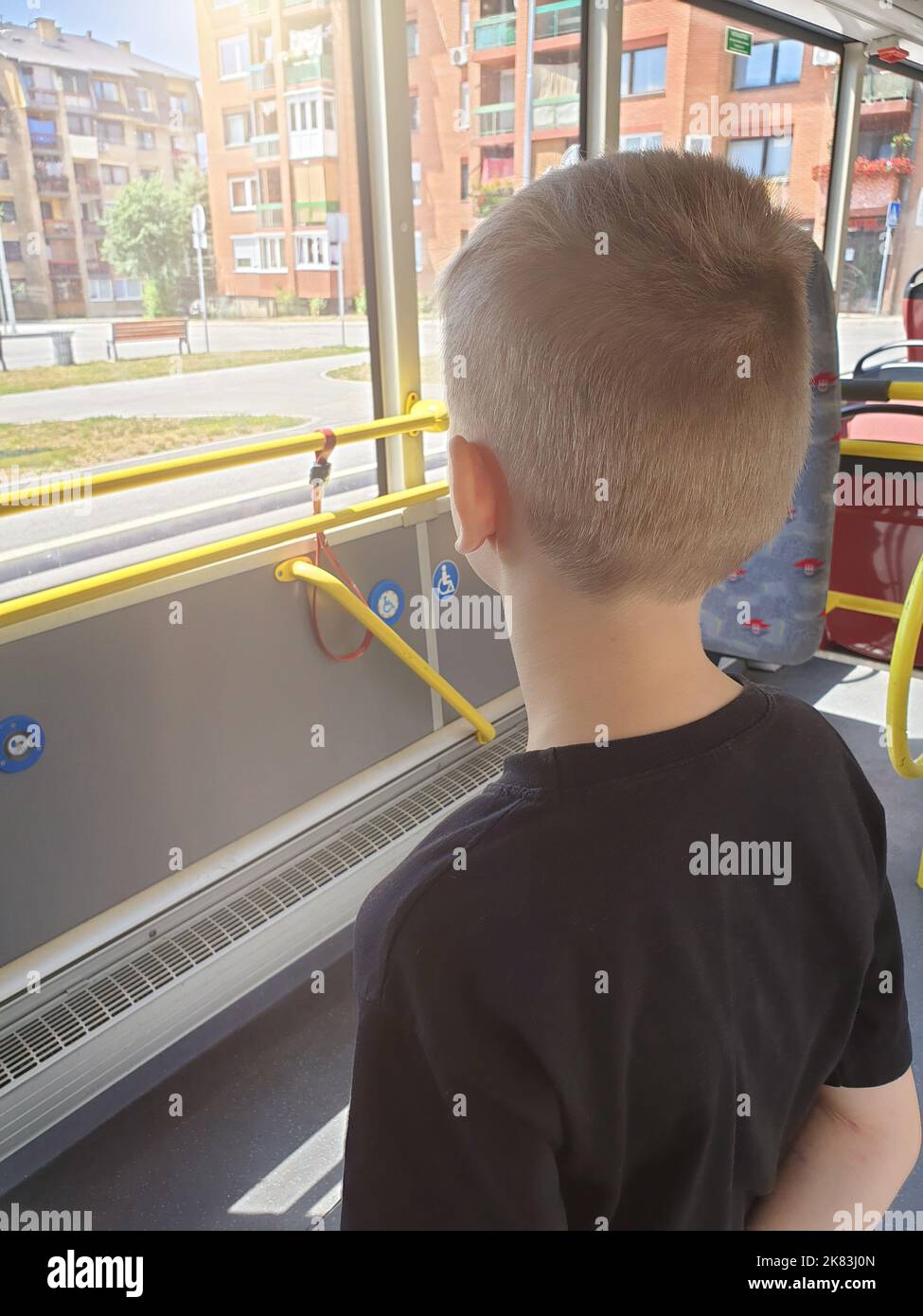Boy in a public transport. Cute boy standing in empty schoolbus Stock ...