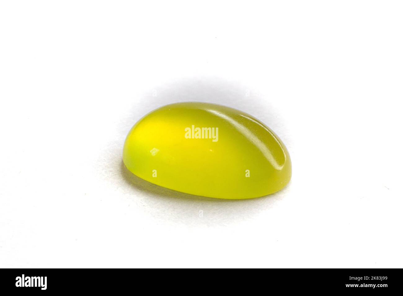 Two Peridots on top of each other on a white background. Olivine oval ...