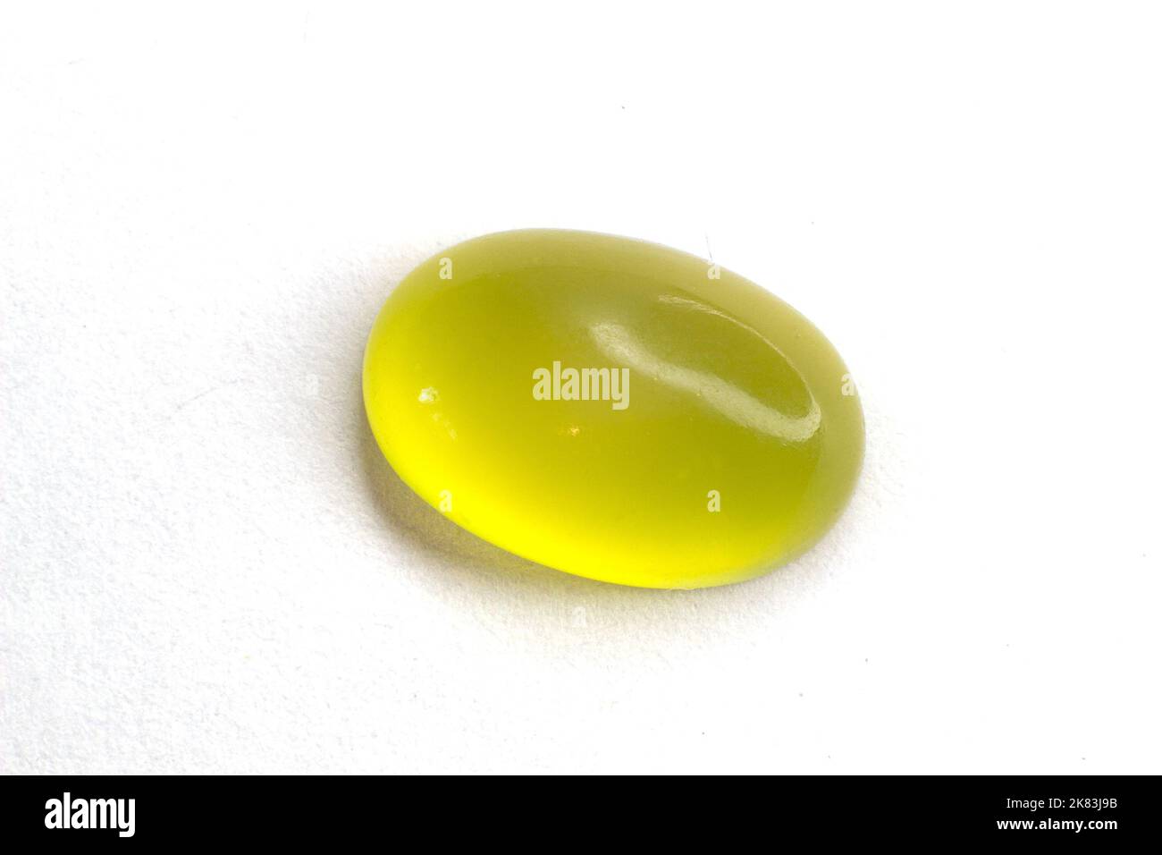 Two Peridots on top of each other on a white background. Olivine oval ...