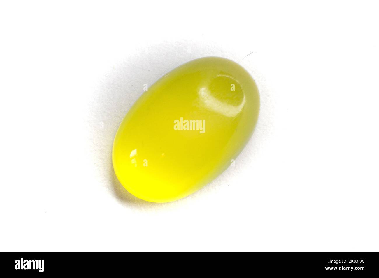 Two Peridots on top of each other on a white background. Olivine oval ...