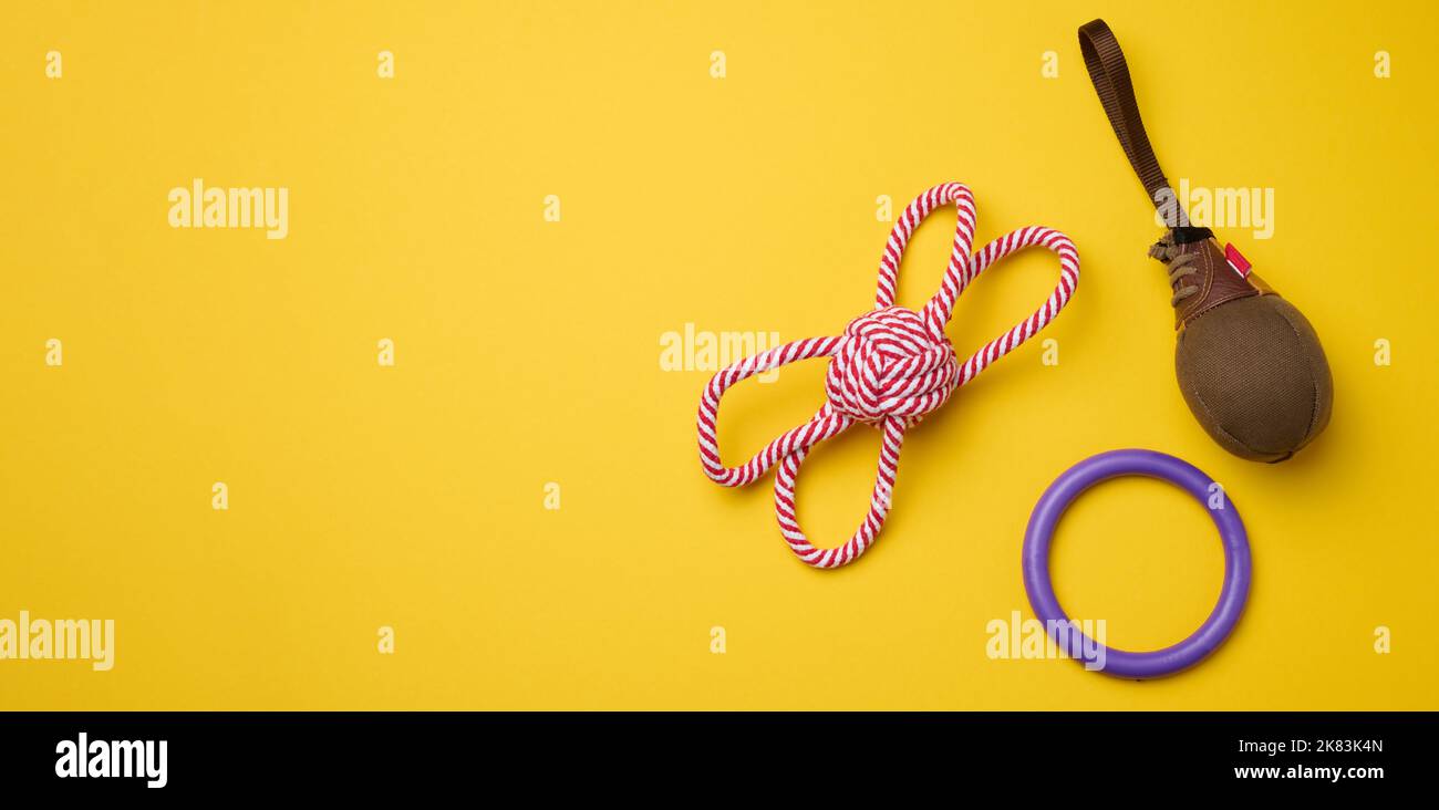 Textile toy, rope for playing with animals on a yellow background, top ...