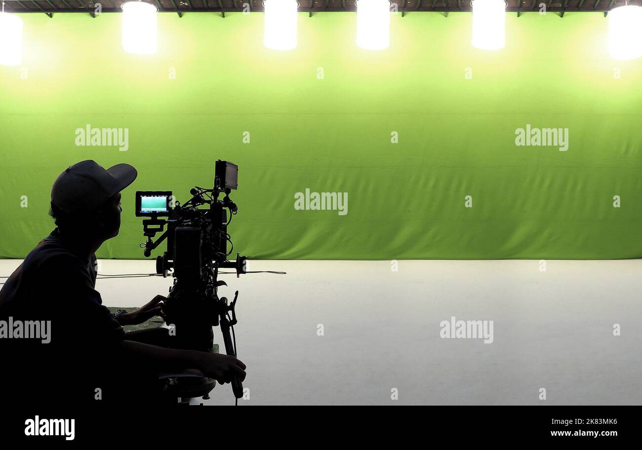 Camera man and tools and white floor and big green screen studio Stock ...