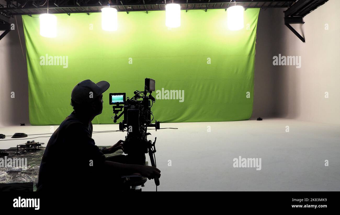 Camera man and tools and white floor and big green screen studio Stock ...