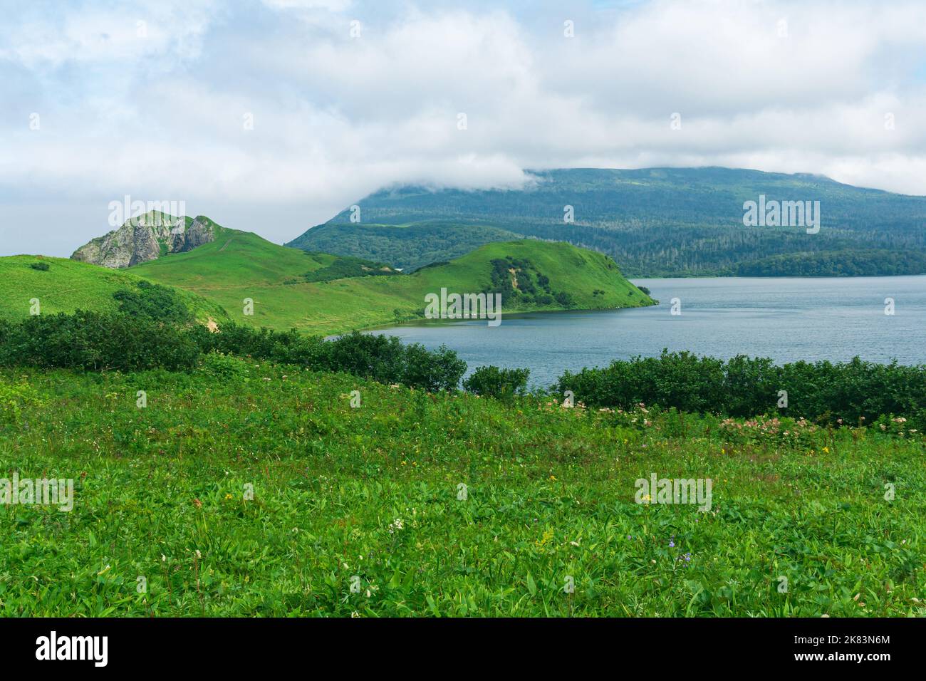 natural landscape of Kunashir island with grassy hills, volcanic rocks ...