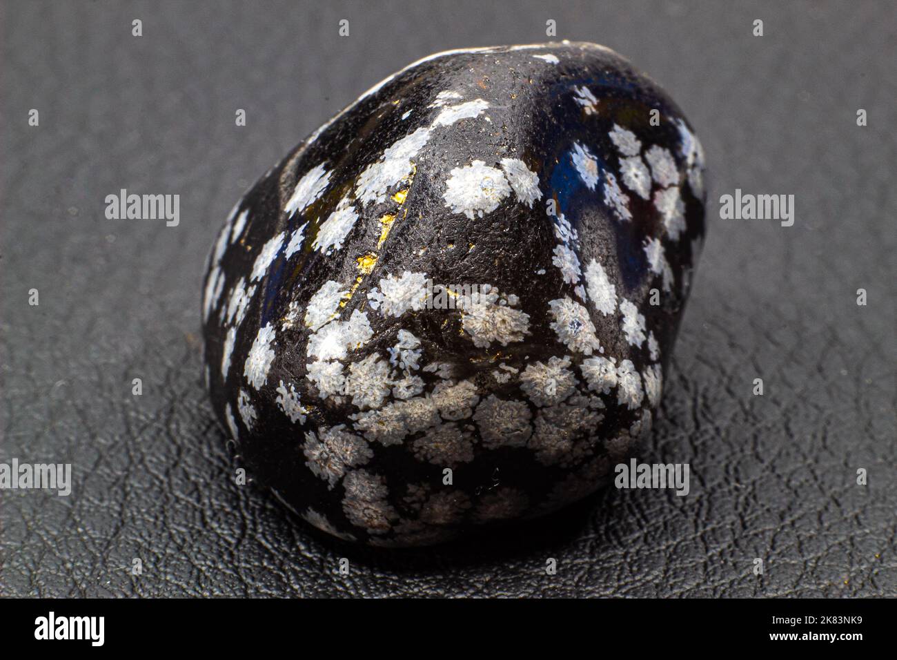 Tumbled close up snowflake obsidian isolated on white background Stock ...