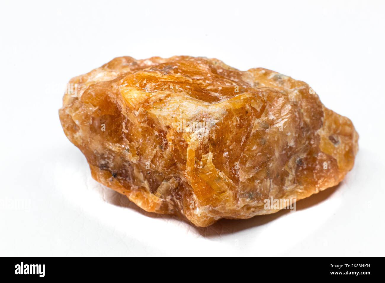 Raw orange calcite stone macro isolated on white background Stock Photo ...