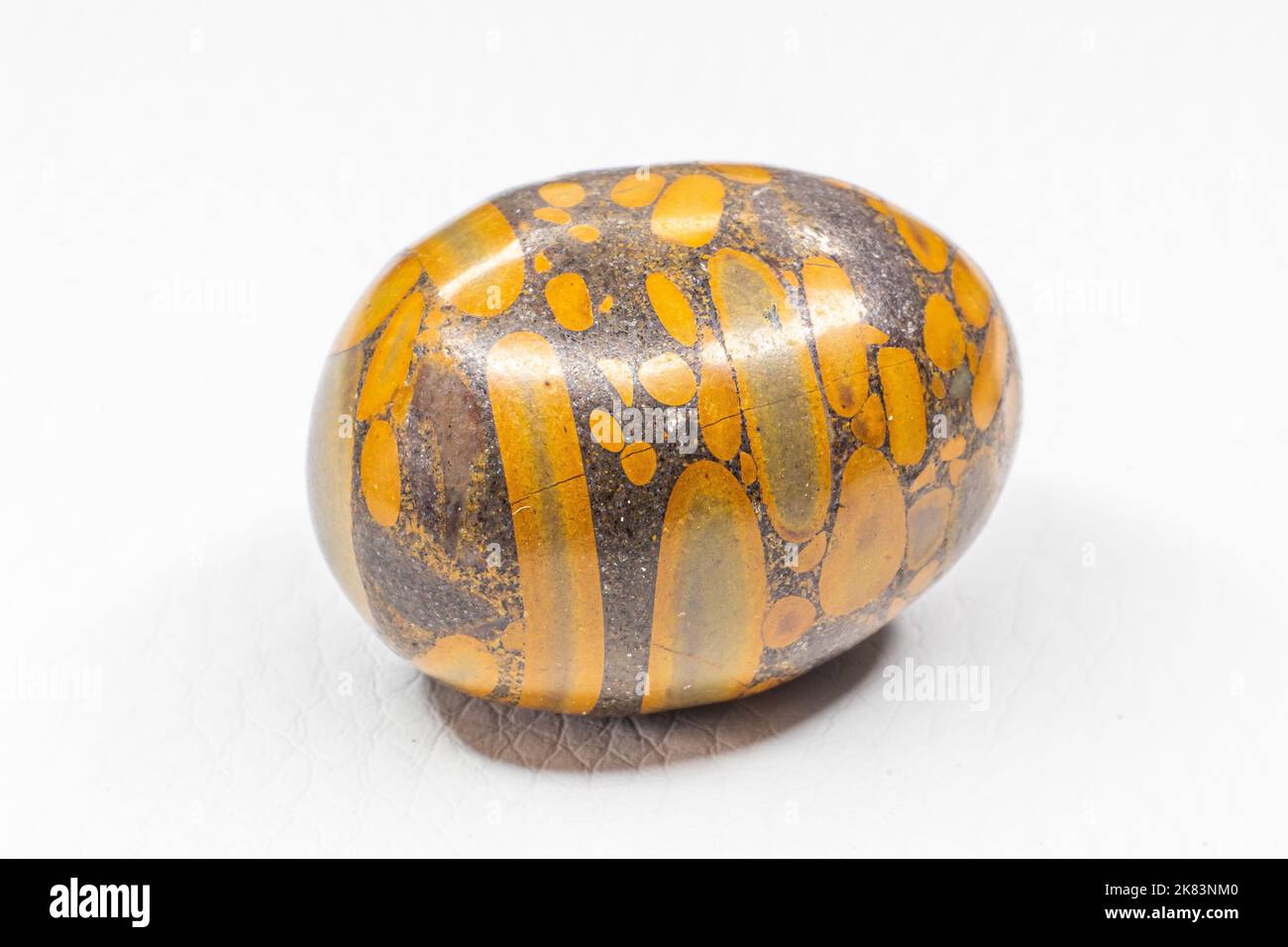 Bamboo leaf jasper tumble isolated on white background Stock Photo - Alamy