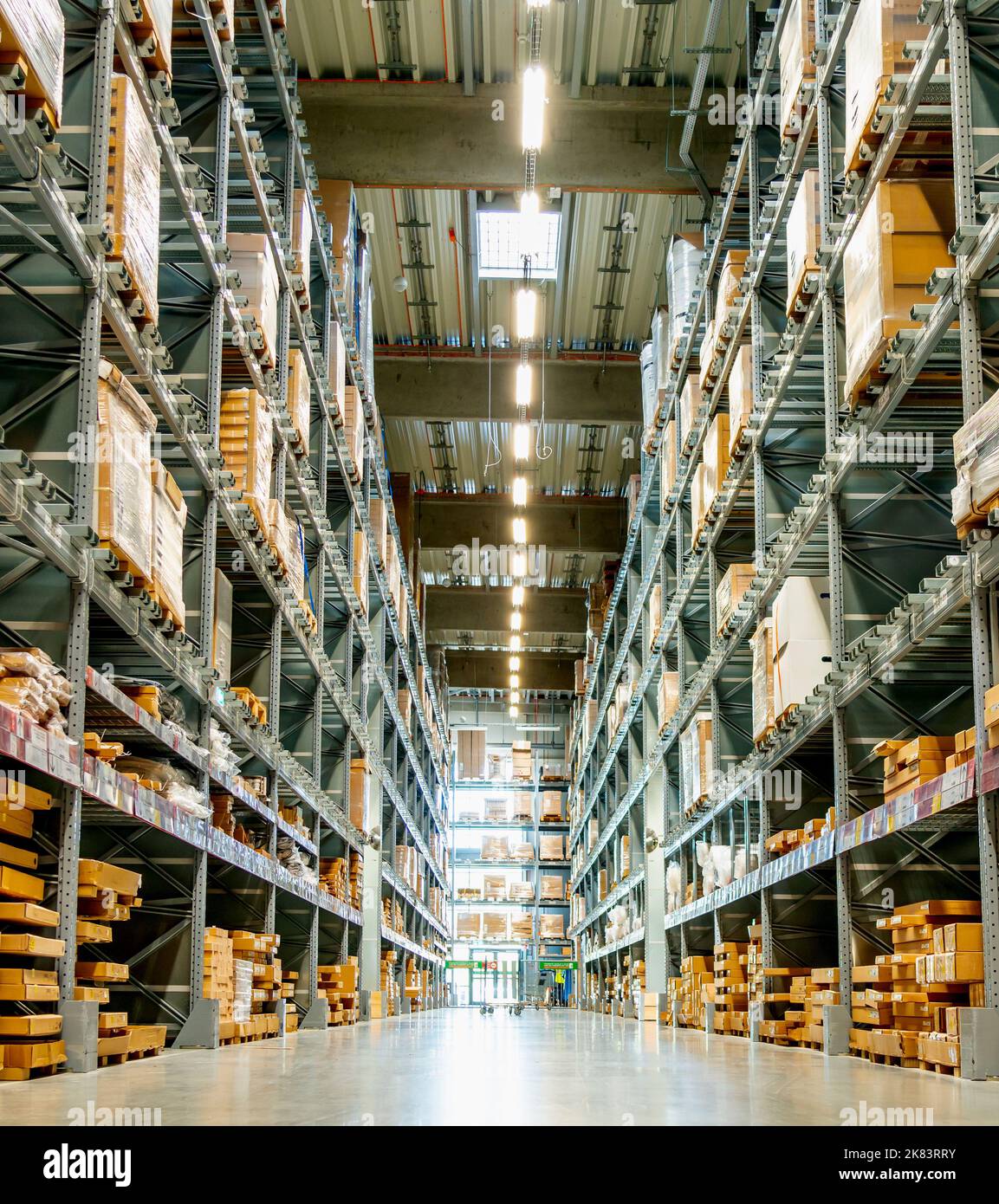 High racks in the aisle in a large warehouse vertical view Stock Photo ...