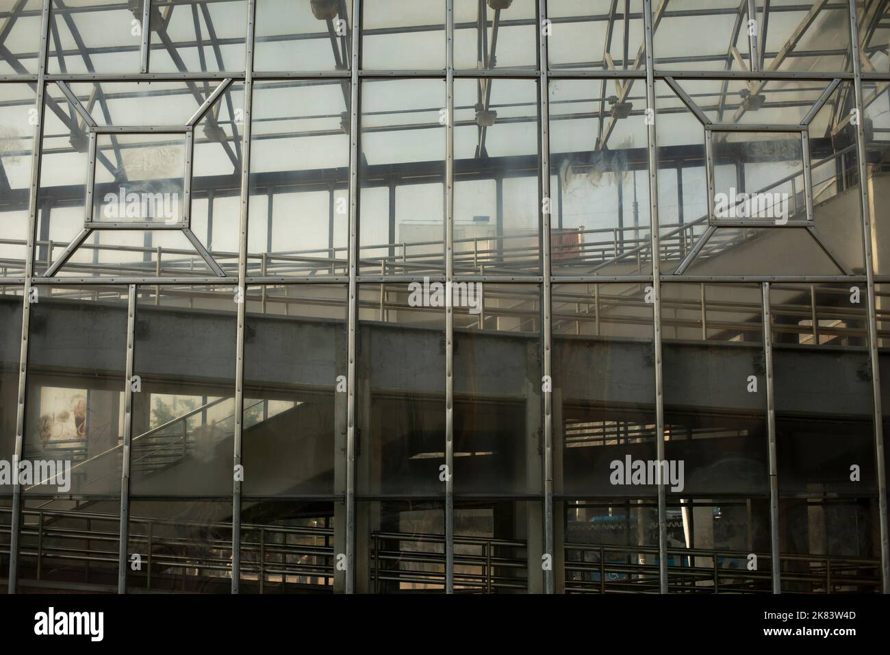 Glass pedestrian crossing building. Bridge over road. Interchange ...