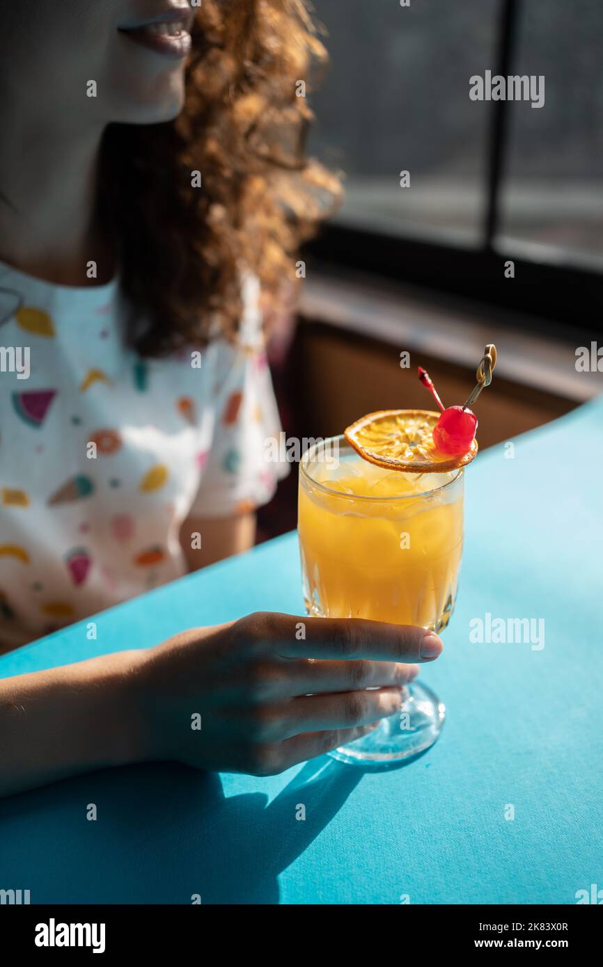 female drink fresh tequila sunrise orange cocktail with slice of citrus ...