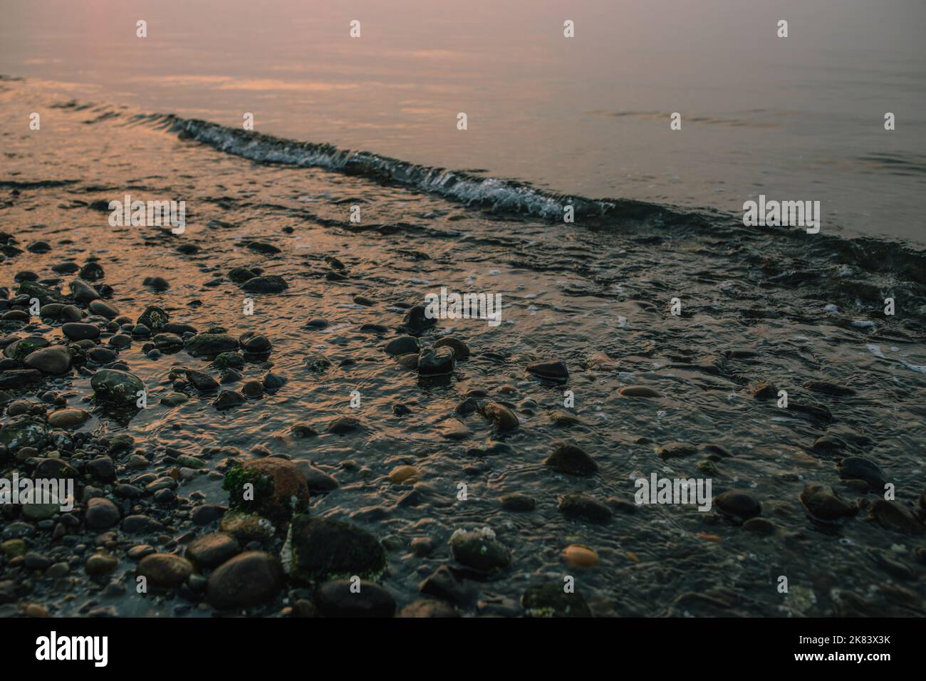 rocky Pacific Northwest beach during a smoky sunset Stock Photo - Alamy