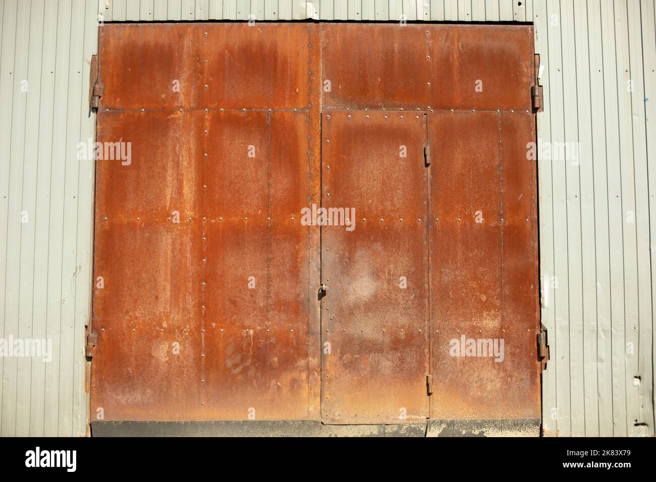 Big rusty gates. Entrance for trucks. Closed gates in industrial area ...