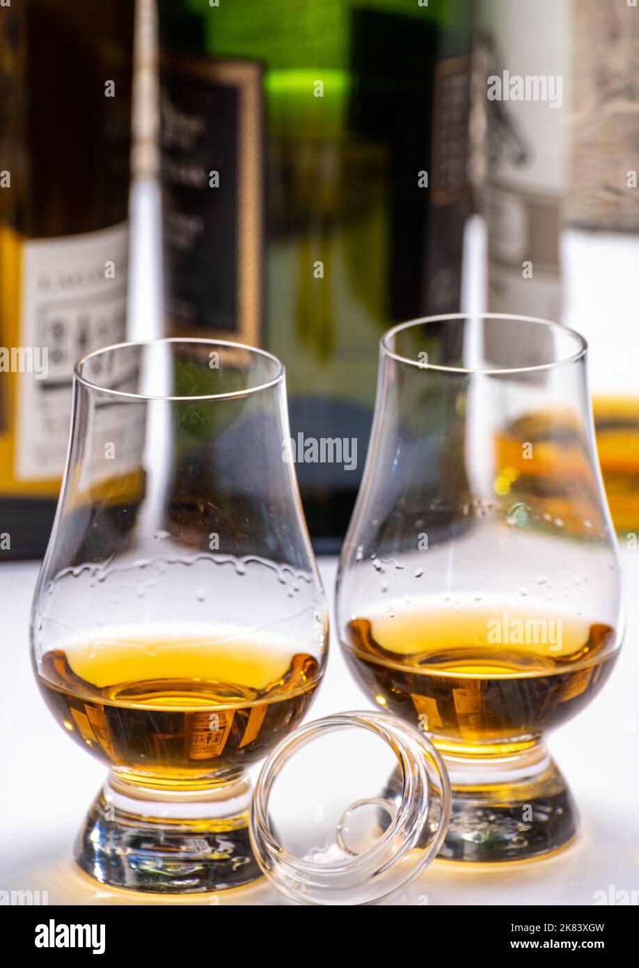 Tasting of whiskey, tulip-shaped tasting glasses with dram of Scotch ...