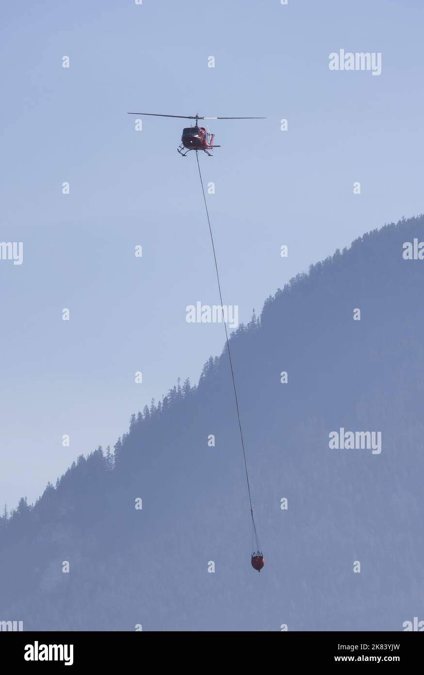 Wildfire Service Helicopter flying over BC Forest Fire and Smoke on the ...
