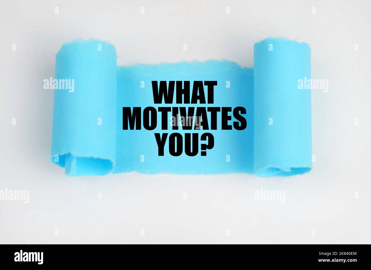 On a white surface, a blue scroll of paper with the inscription - WHAT ...