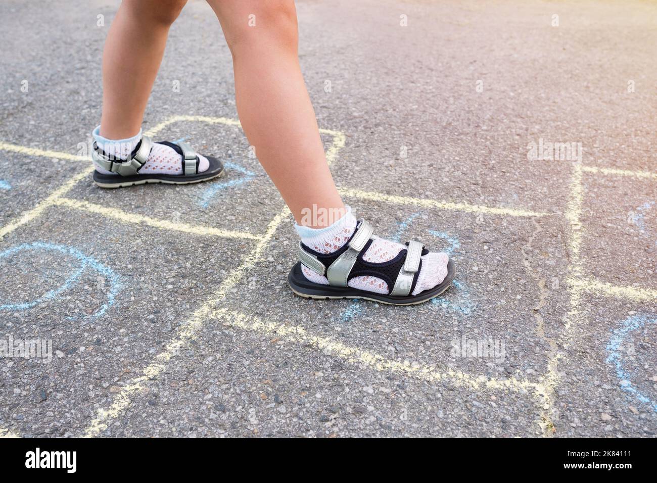 Children's feet and drawings with chalk on the pavement closeup Stock ...
