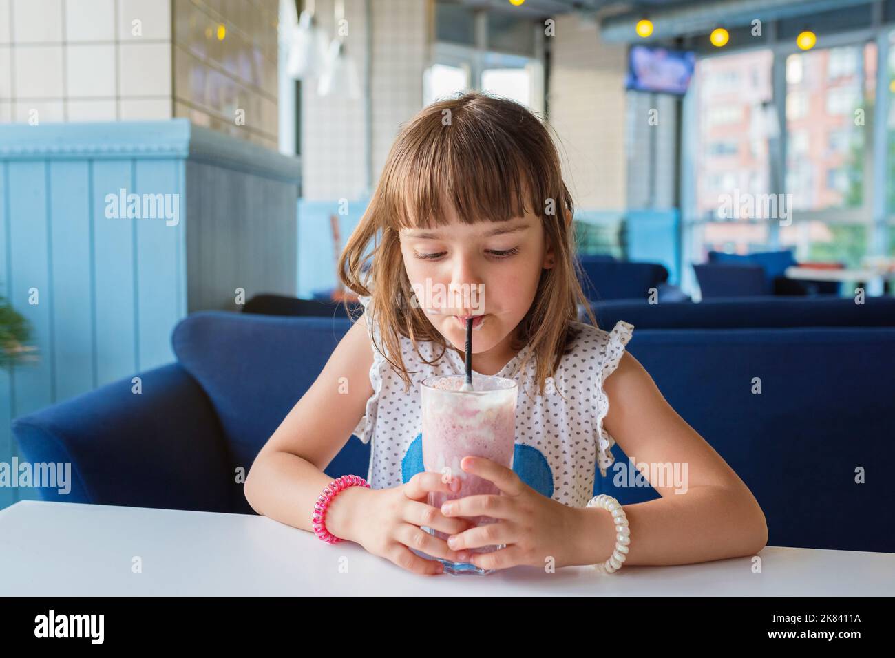 A girl in a cafe, drinking a milkshake. Healthy food Stock Photo - Alamy