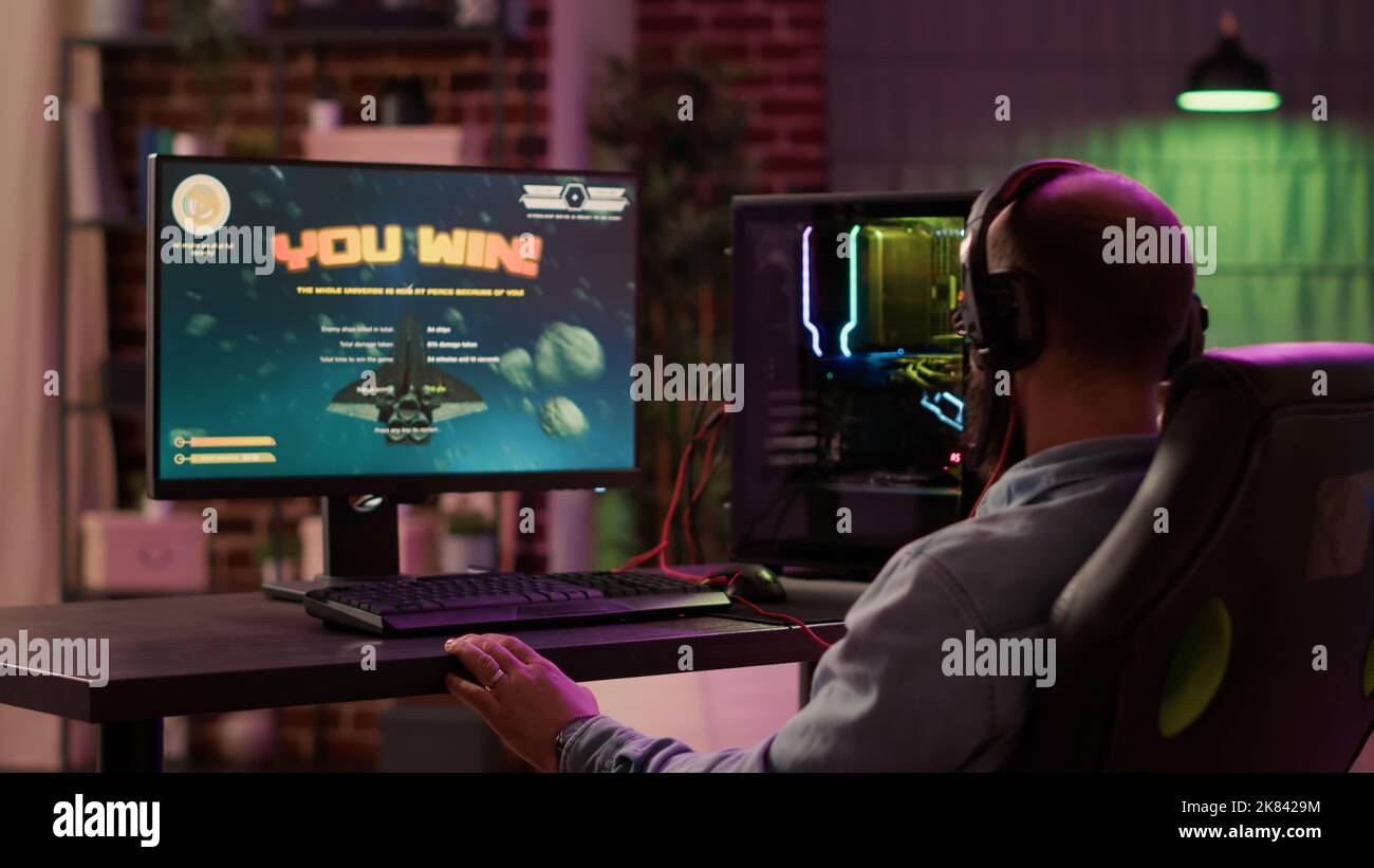 Caucasian gamer playing fast paced space shooter simulation enjoying ...