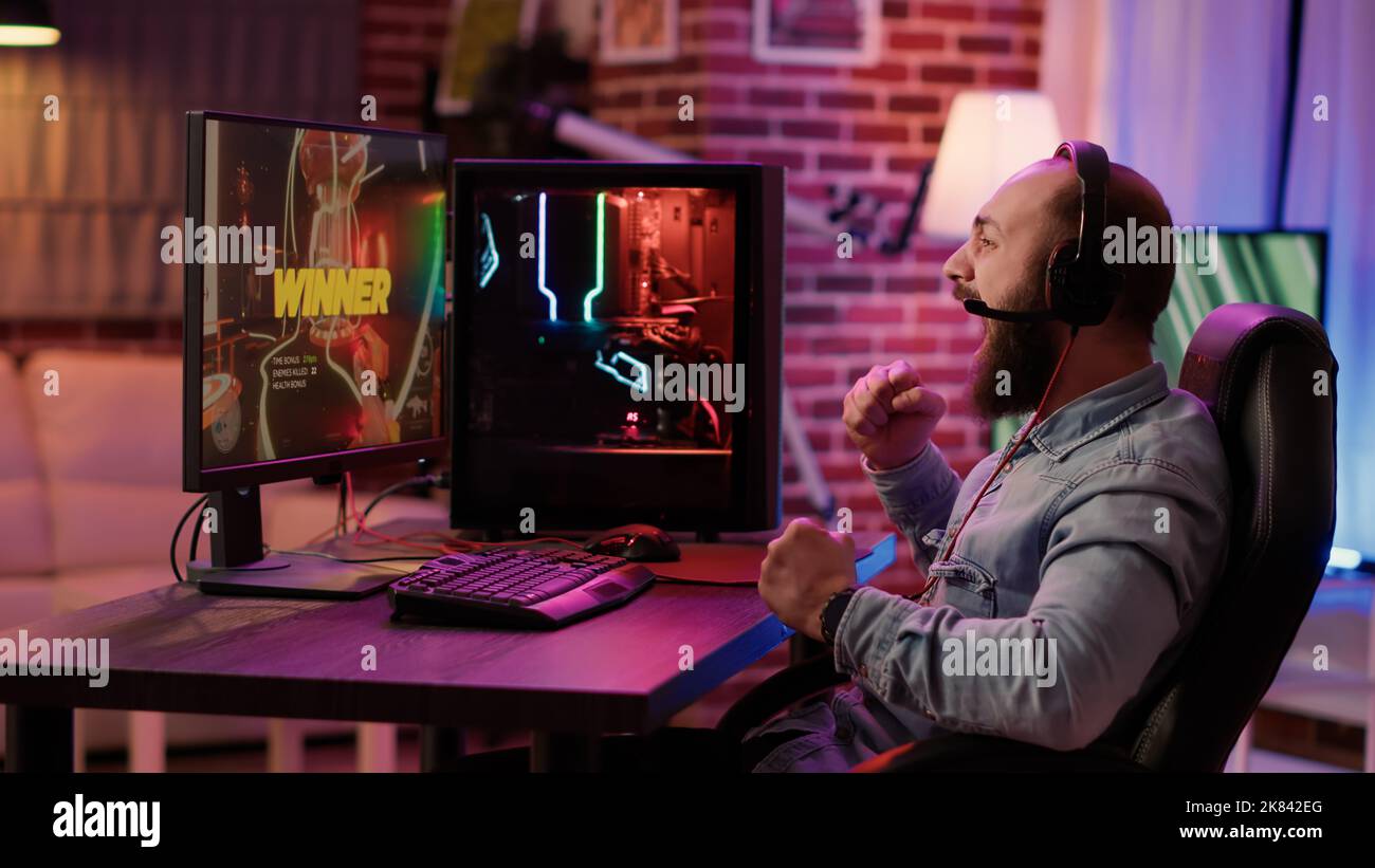 Handheld shot of streamer doing victory hand gesture after win in ...