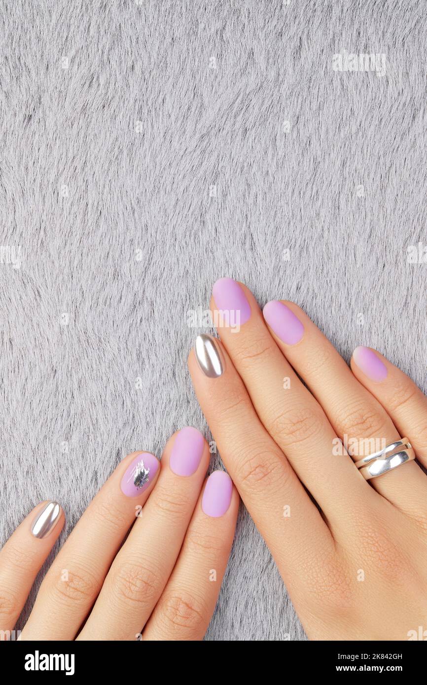 Beautiful groomed womans hands with matte lavender nail design on furry ...