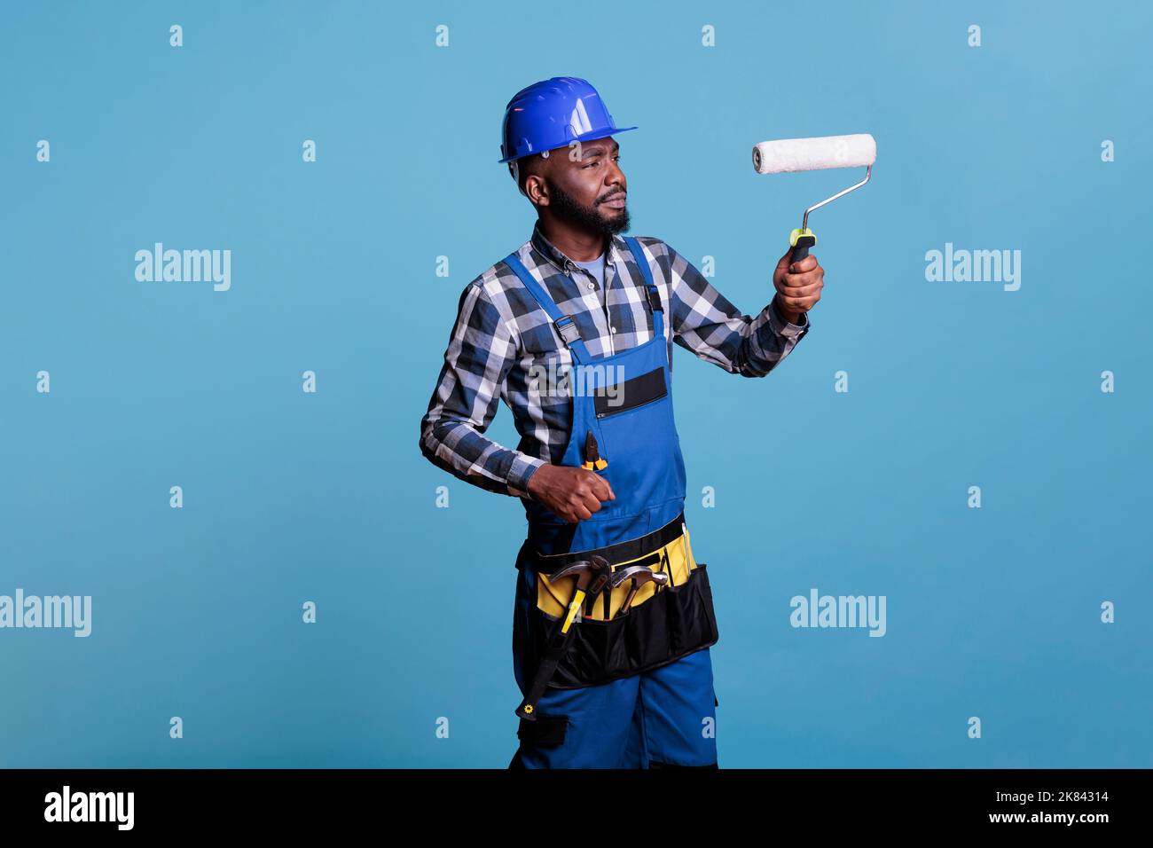 Builder wearing helmet painting wall hi-res stock photography and ...
