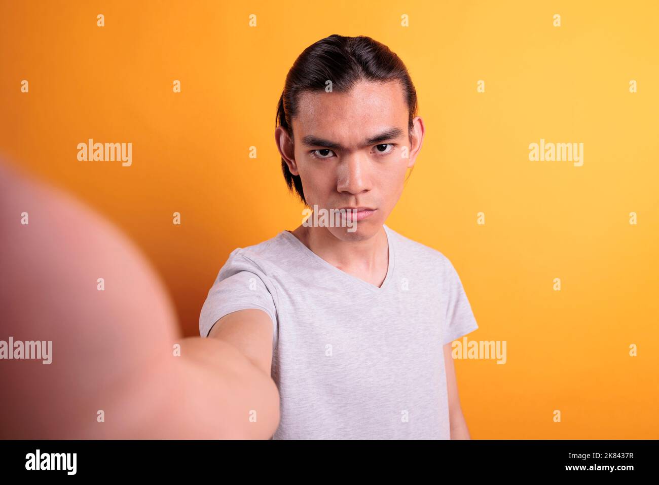 Angry man talking on video call, taking selfie on smartphone, looking ...