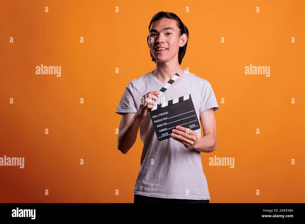 Cameraman assistant holding film making clapperboard, movie scene ...