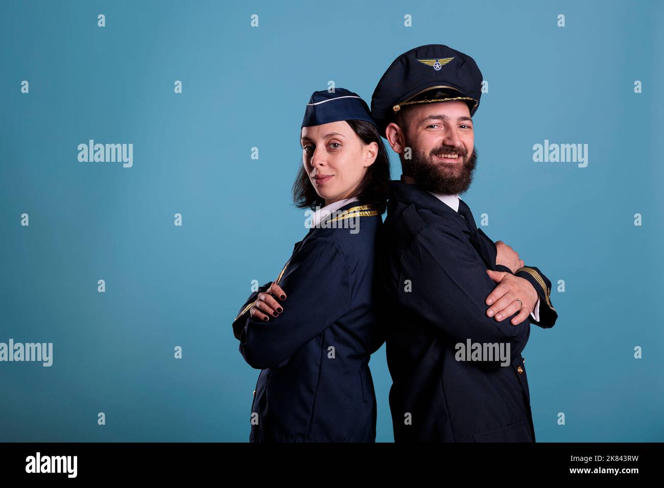 Airplane pilot and flight attendant in professional uniform standing ...