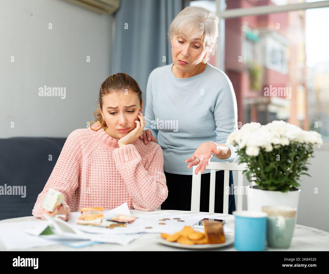 Upset aged female counting coins hi-res stock photography and images ...