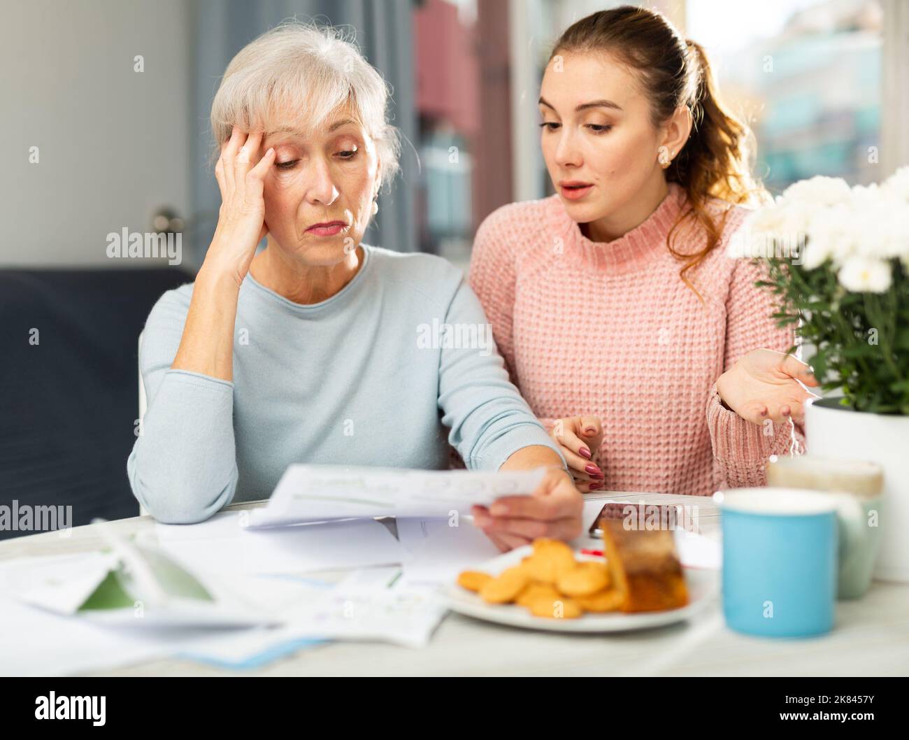 Mother and daughter figuring out finance problem Stock Photo - Alamy